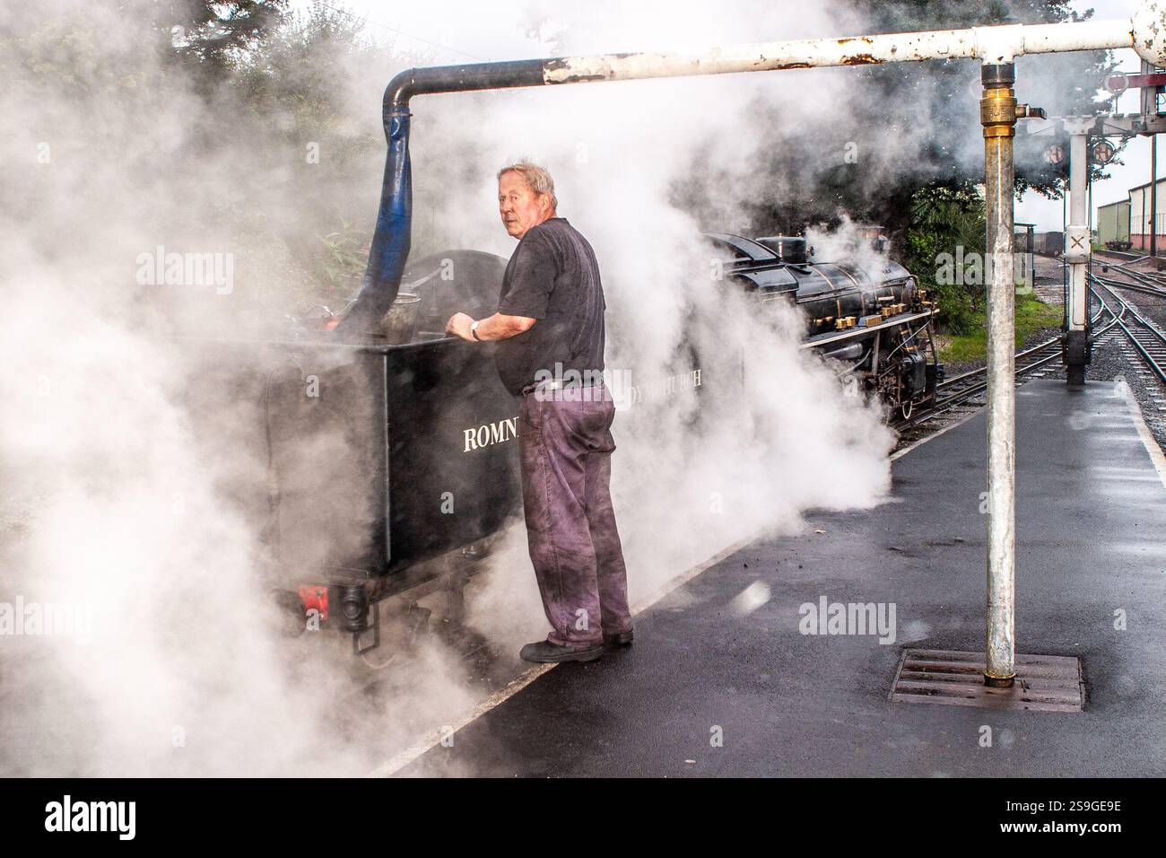 Topping up No.10 Doctor Syn narrow gauge steam locomotive with water at ...