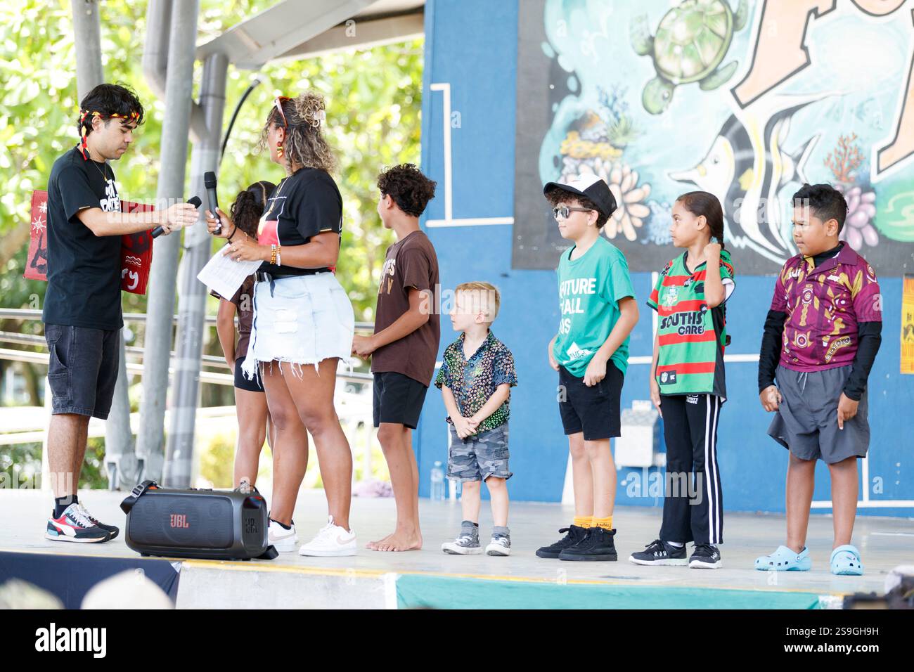 Cairns, Australia. 26th Jan, 2025. Children stand in front of the crowd ...