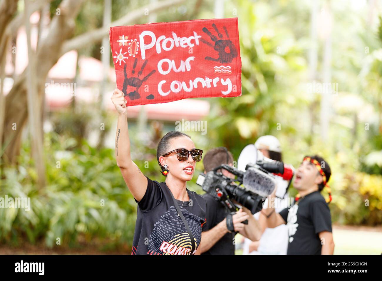 Cairns, Australia. 26th Jan, 2025. Demonstrator holds a placard during ...