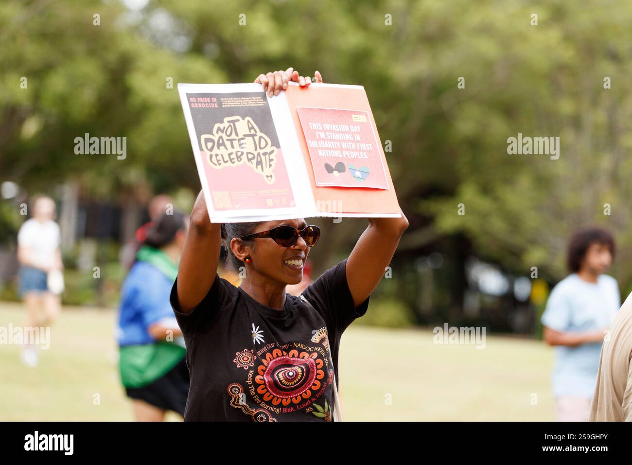 Cairns, Australia. 26th Jan, 2025. Demonstrator holds a placard during ...