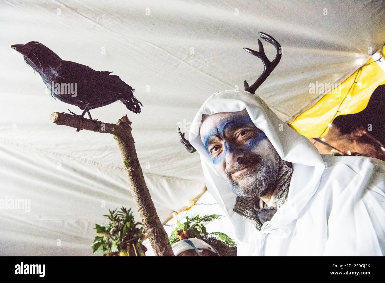 Man wearing antlers in face paint dressed as a wassail pagan with white ...