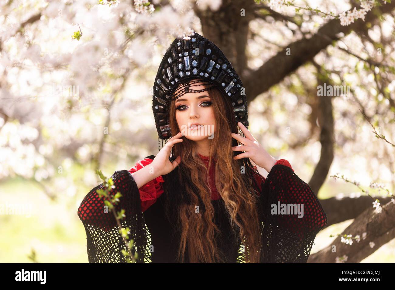 Girl in national Russian red dress and kokoshnik leaning against ...