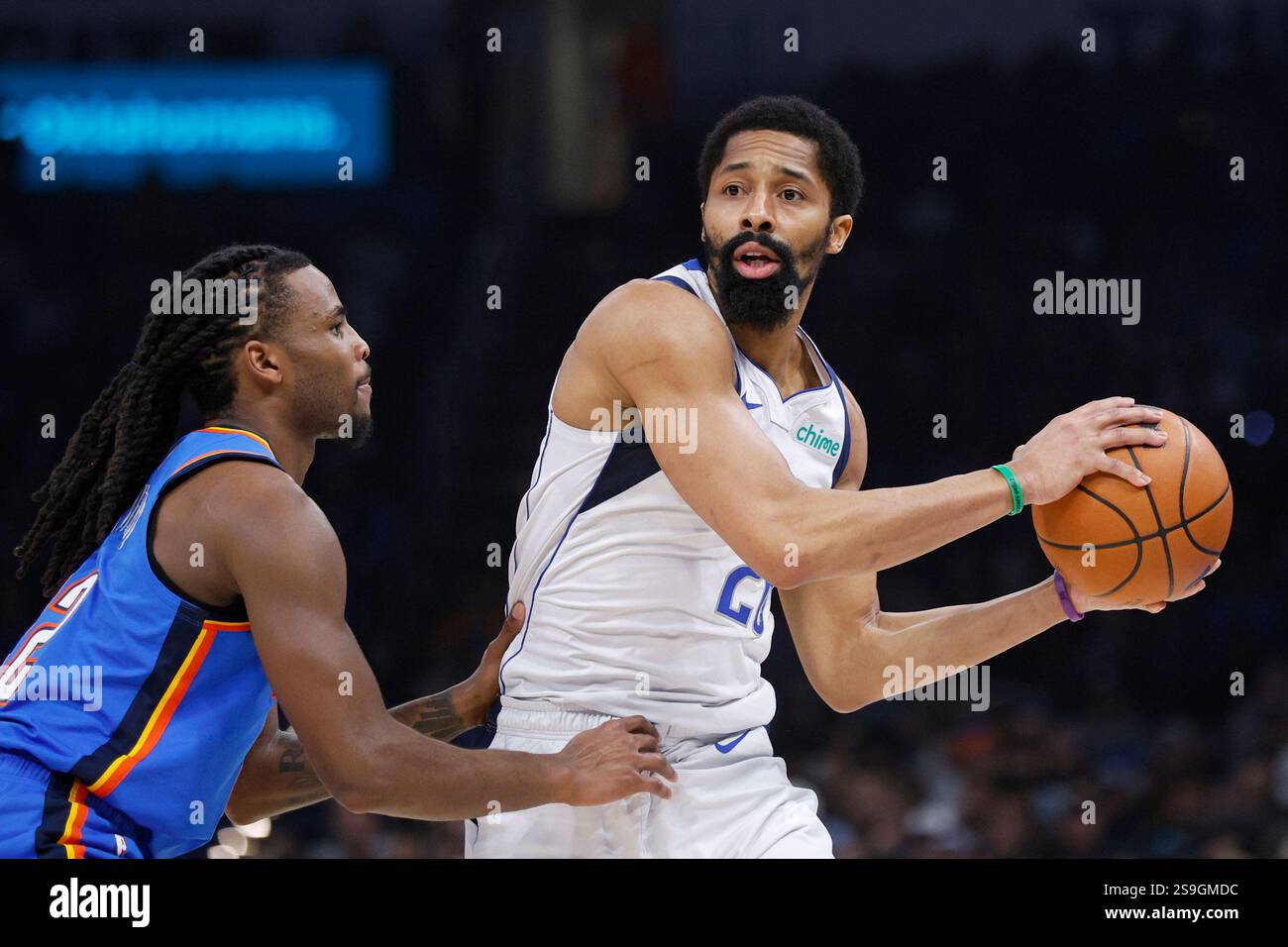 Dallas Mavericks guard Spencer Dinwiddie, right, looks to pass the ball ...