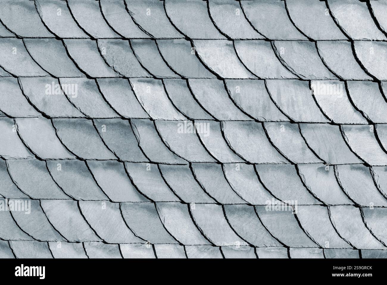 Detail close-up of natural grey stone shingle slate tiles texture roof ...