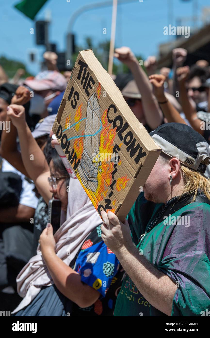 Protester holds a placard during the 2025 Invasion Day rally. Thousands ...