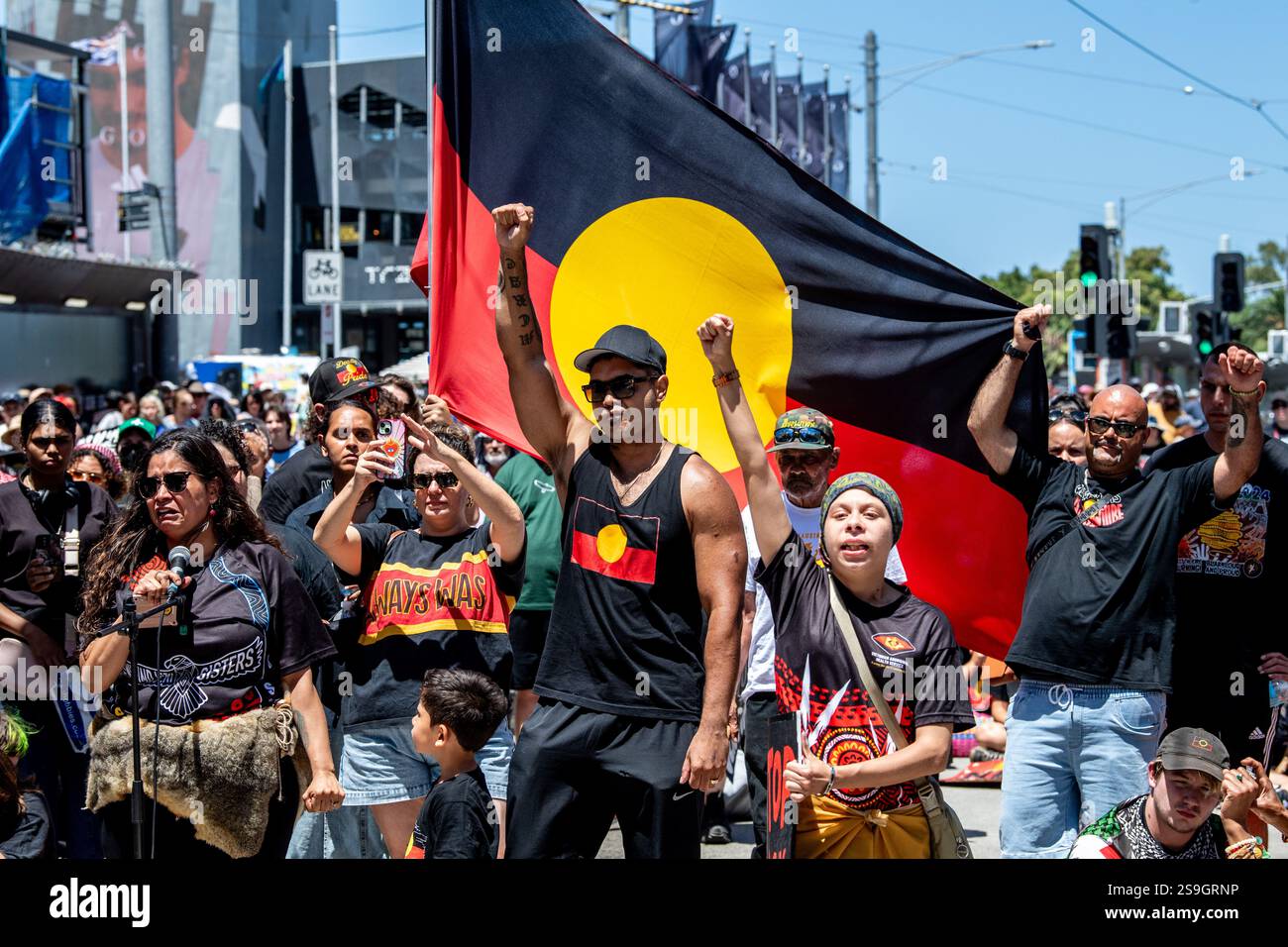 Participants raise their fists in solidarity during the 2025 Invasion ...
