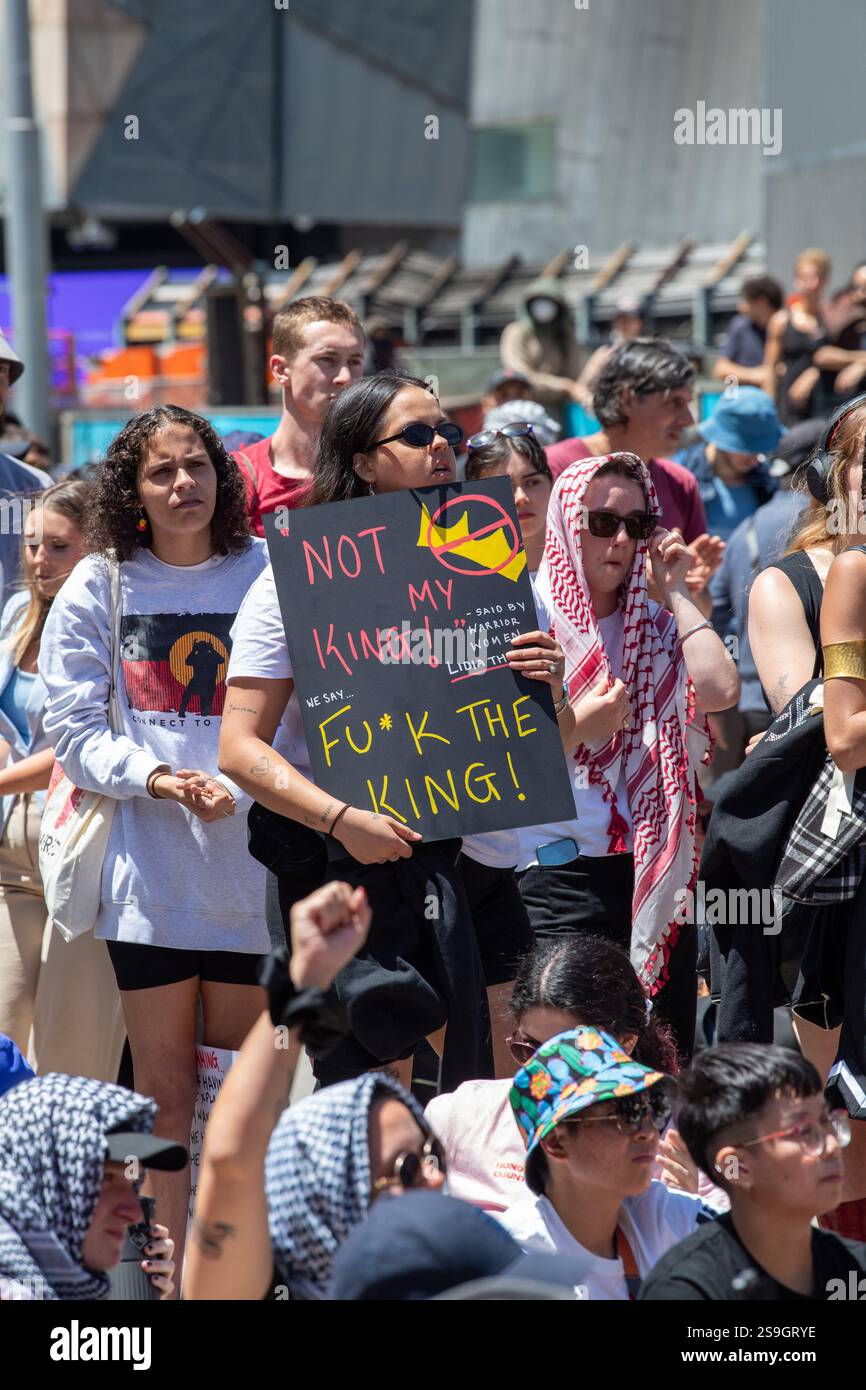 Protester holds a placard during the 2025 Invasion Day rally. Thousands ...
