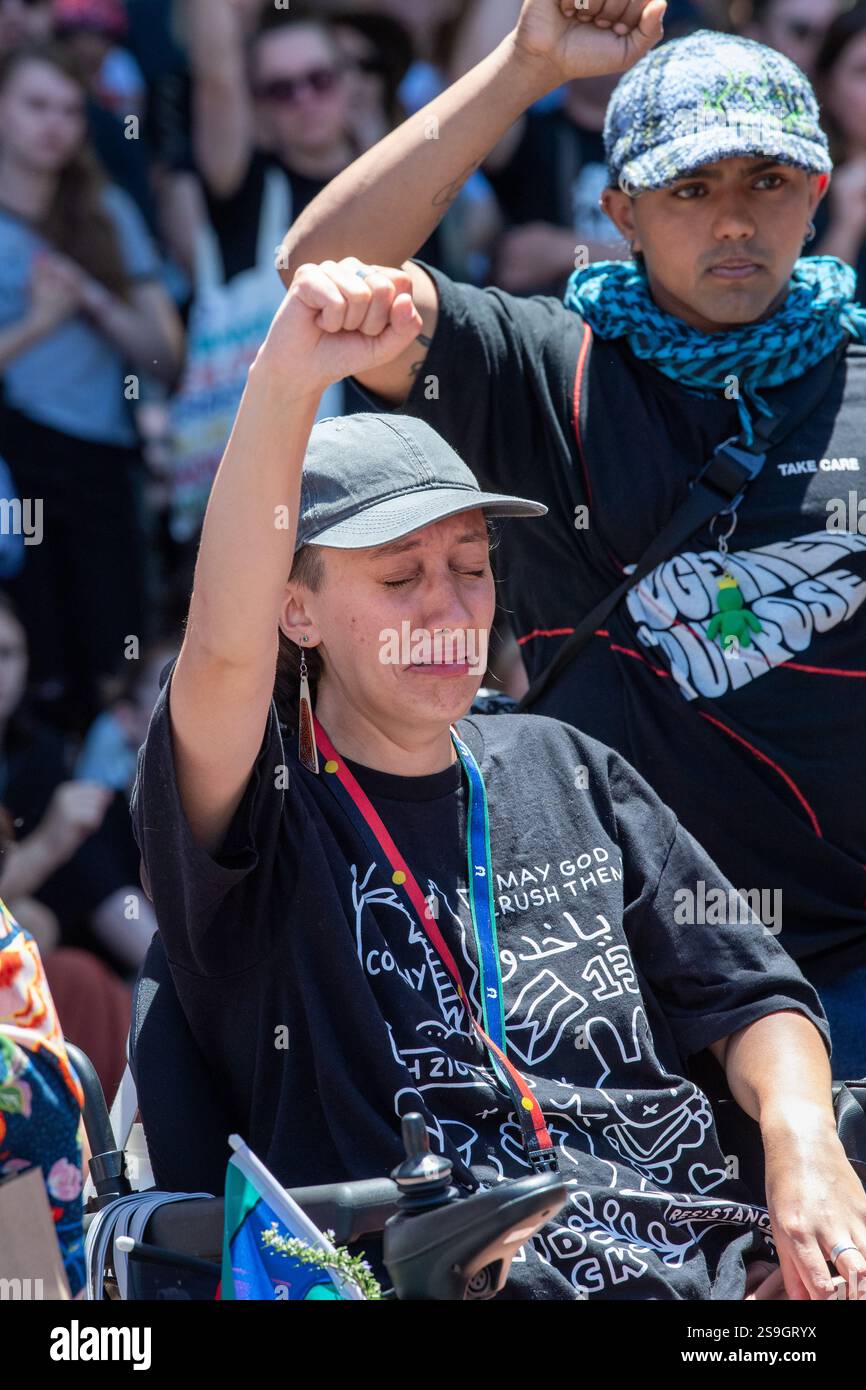 Participants raise their fists in solidarity during the 2025 Invasion ...