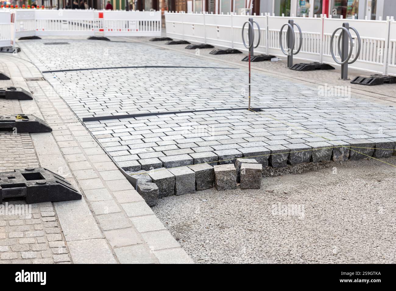 Construcion site of pavement granite cobblestone road in old city ...