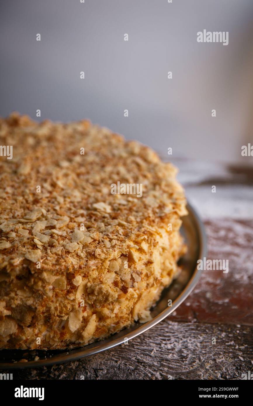 A close-up of a sumptuous Napoleon cake with multiple flaky layers ...