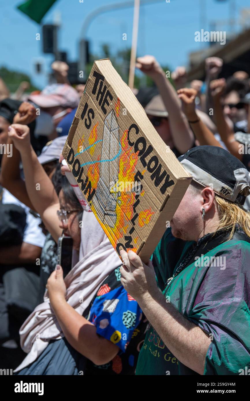 Protester holds a placard during the 2025 Invasion Day rally. Thousands ...