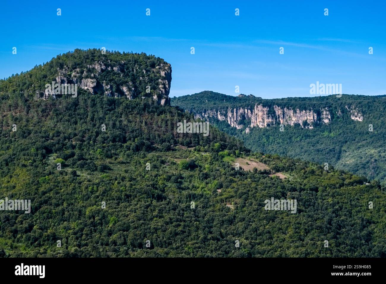 Landscape with wooded mountain slopes and steep rocky cliffs outside ...