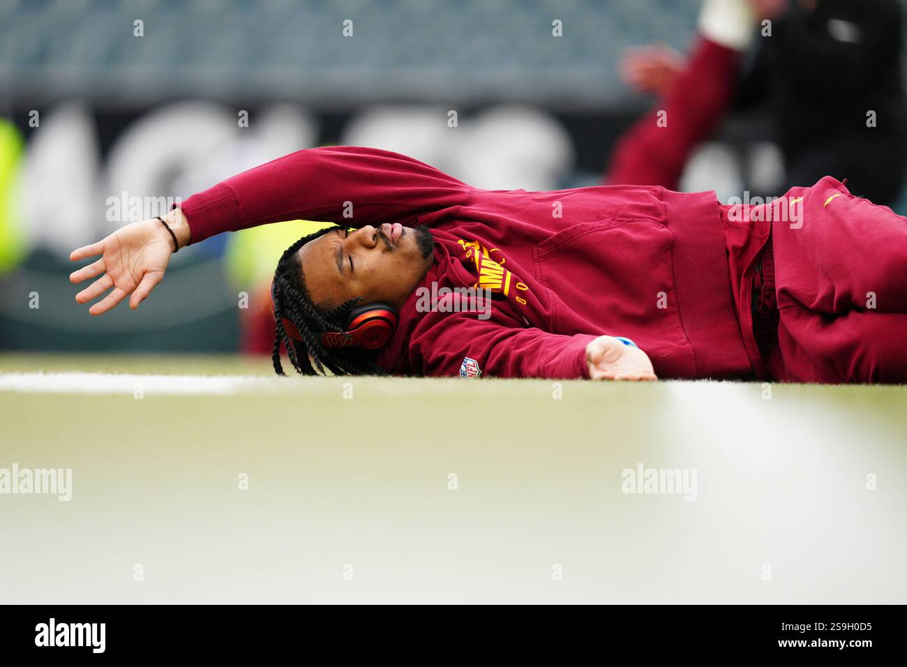 Washington Commanders quarterback Jayden Daniels stretches before the ...