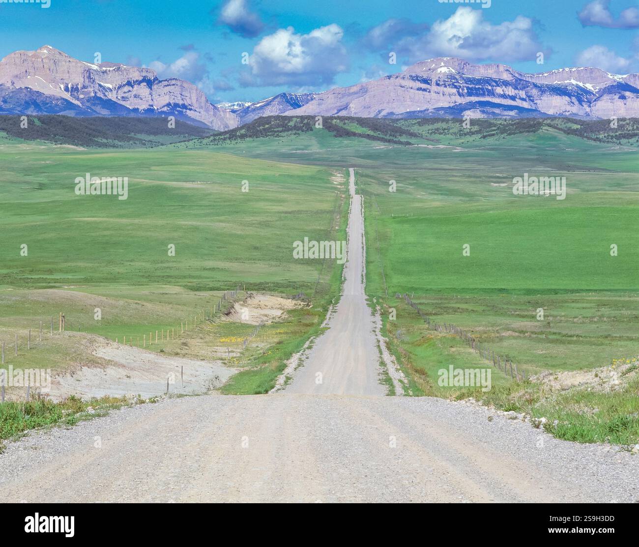 backroad rolling across the prairie to the rocky mountain front near ...