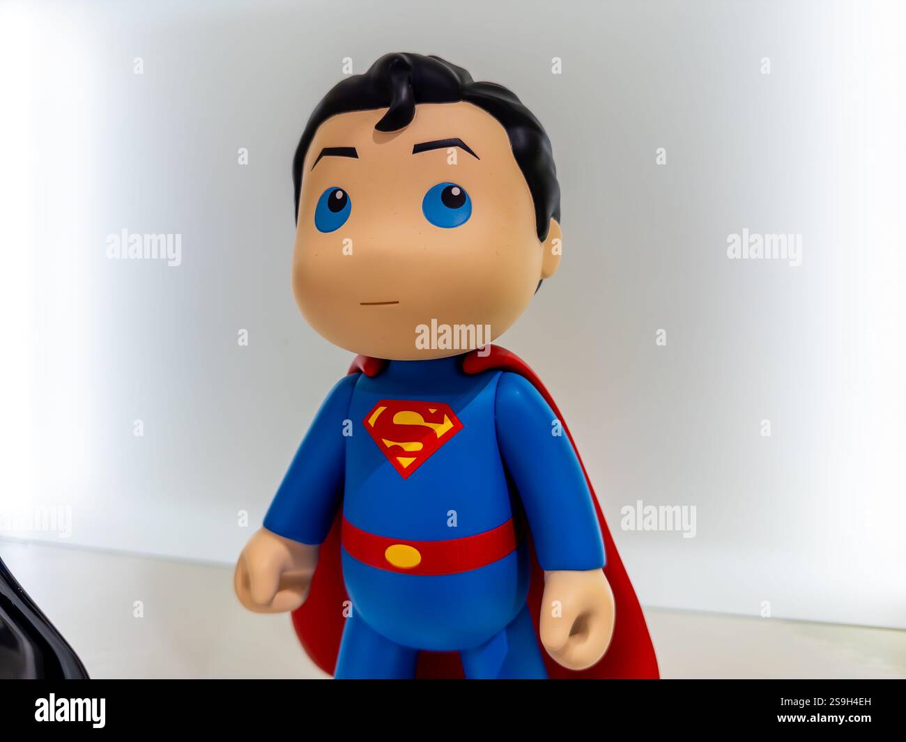 Colorful superhero figurine stands proudly on display amid soft ...