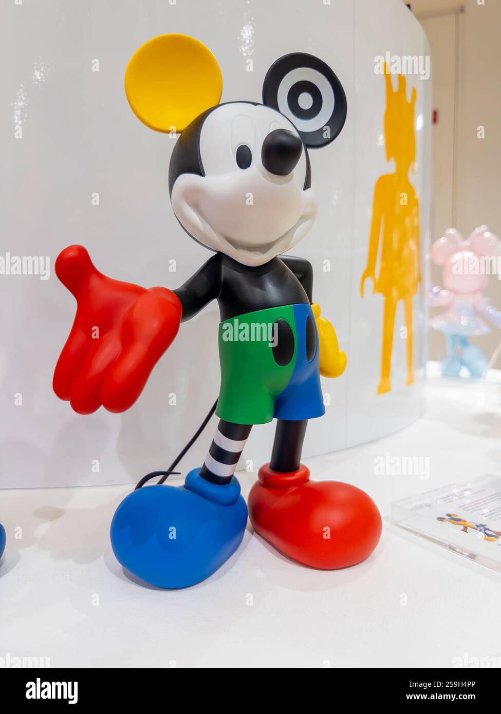 Colorful Mickey Mouse figure stands cheerfully in a modern art gallery ...