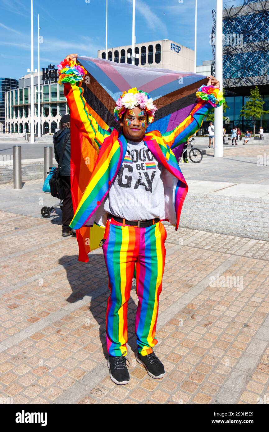 Young asian man celebrating Pride in vibrant rainbow suit & umbrella proud to be gay T-shirt ...