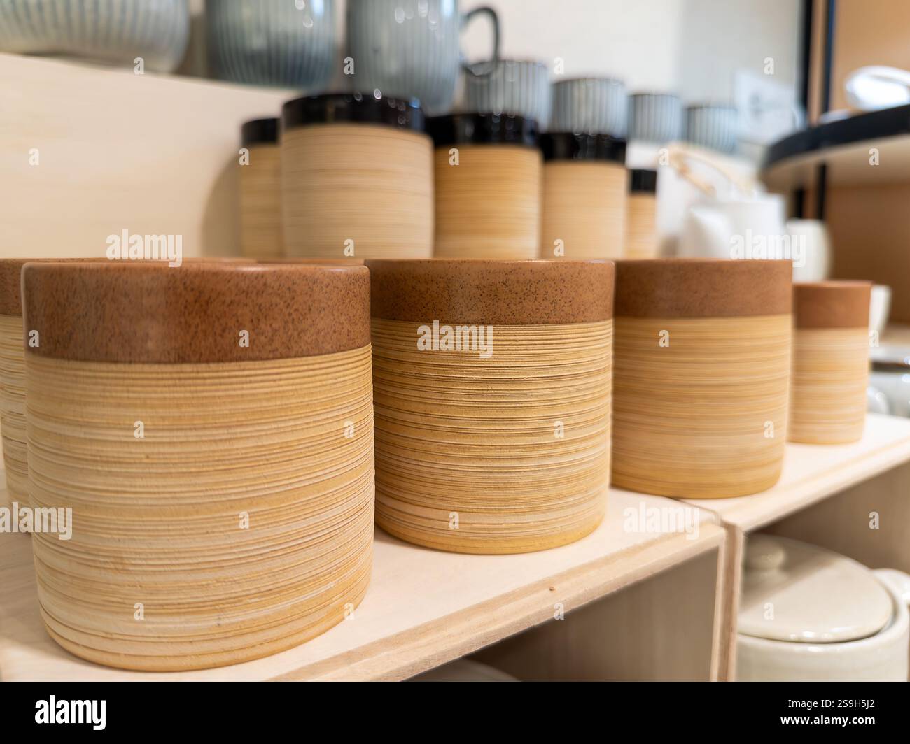 Unique wooden containers arranged neatly on a shelf in a cozy interior ...