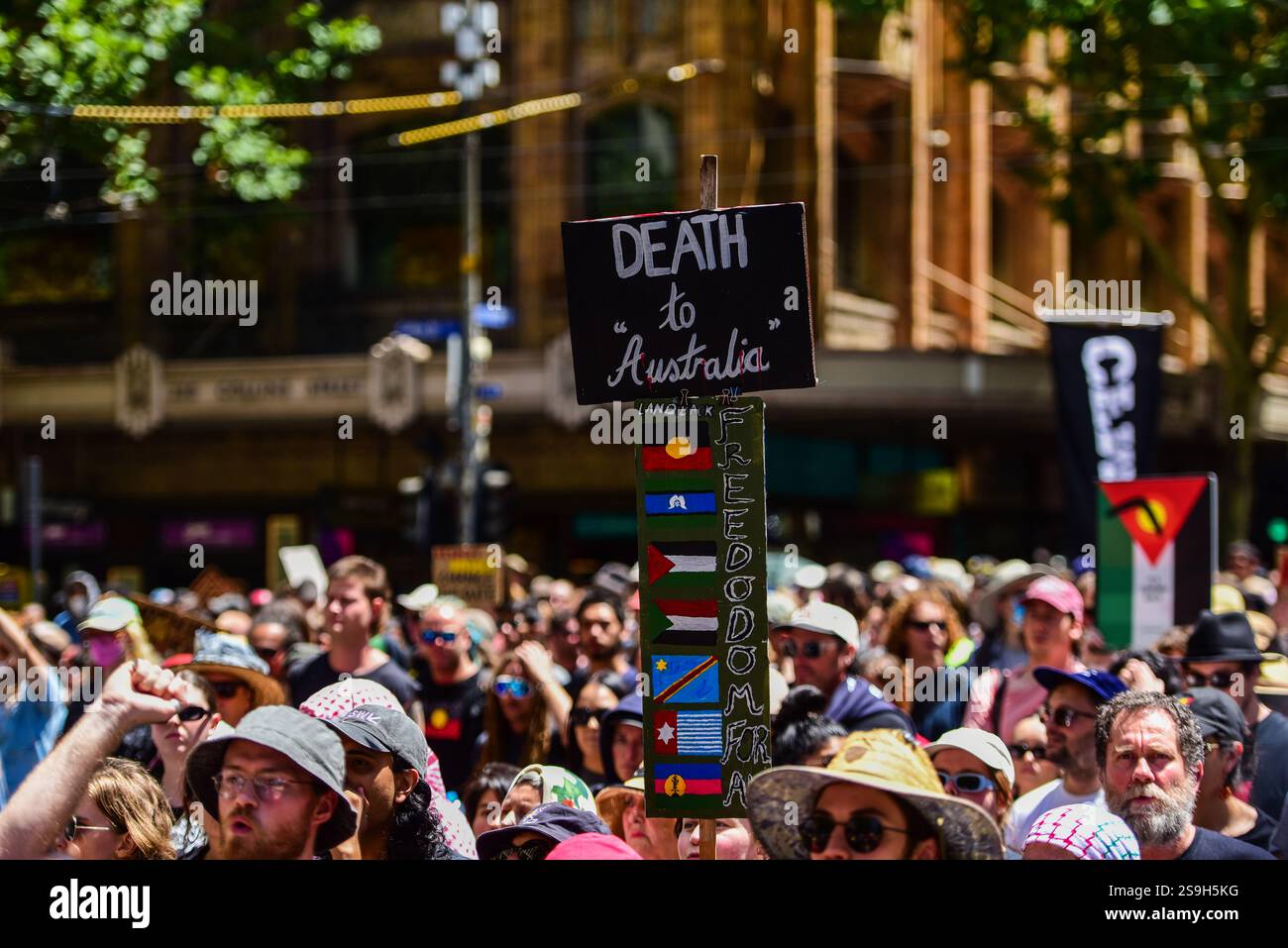 A protester holds a placard reading "Death to Australia" during ...