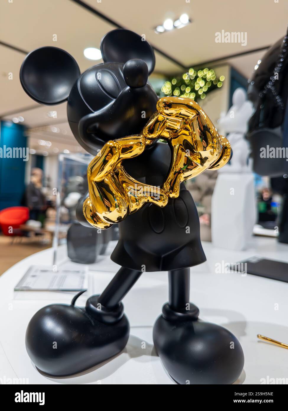 Creative black and gold Mickey Mouse statue display in modern retail ...