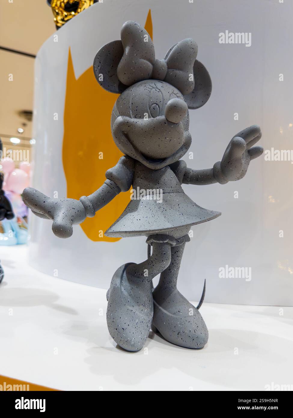 Colorful cute statue in a lively shopping scene Stock Photo - Alamy
