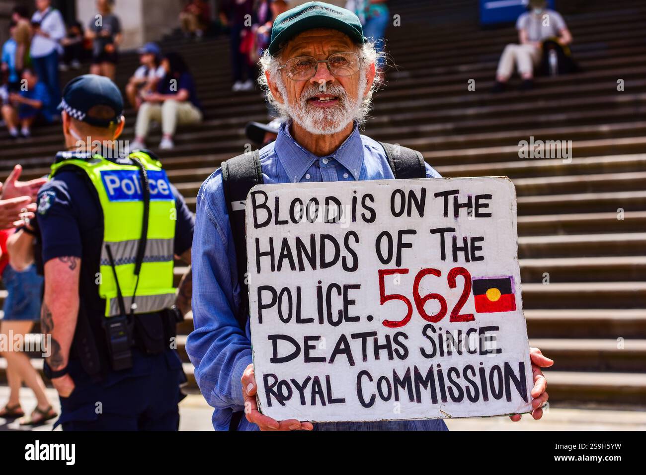 A protester holds a placard during "Invasion Day" rally against ...