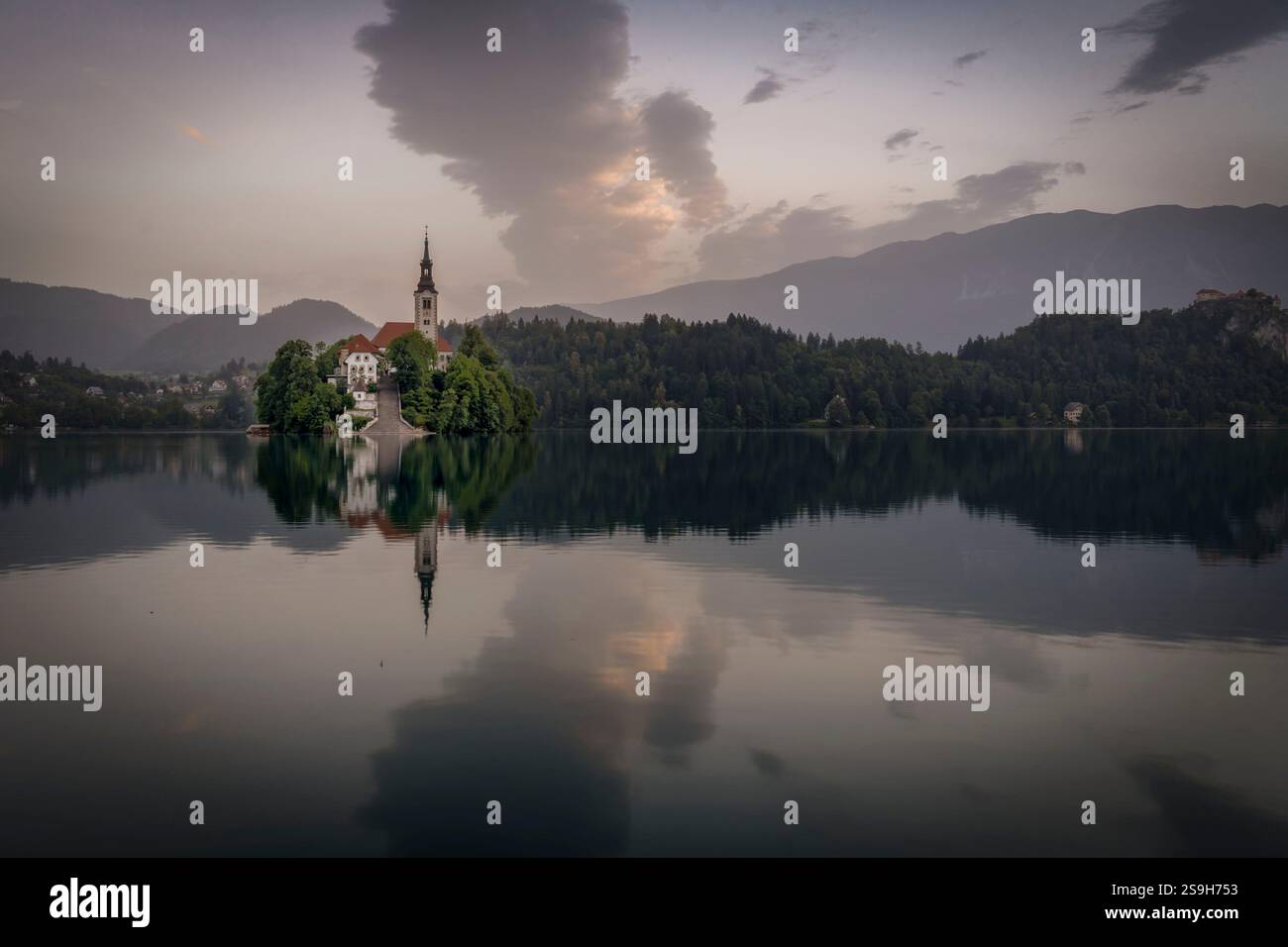 Lake Bled during golden hour sunrise with reflections Stock Photo - Alamy