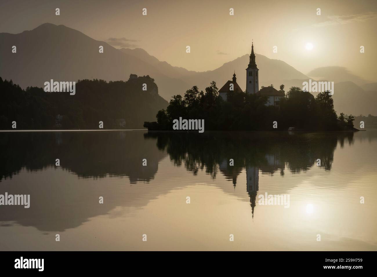 Lake Bled during golden hour sunrise with reflections Stock Photo - Alamy