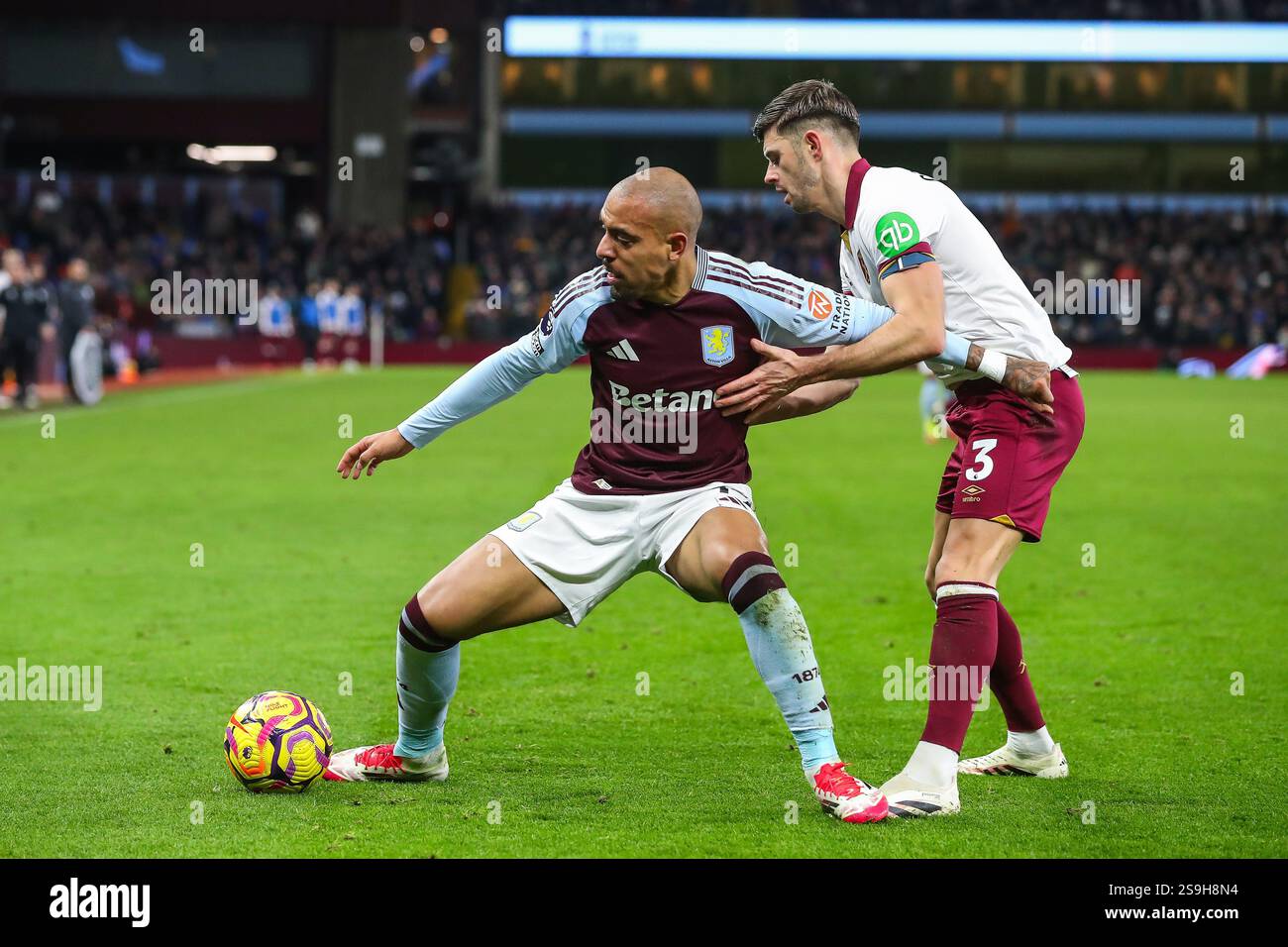 Donyell Malen of Aston Villa holds off Aaron Cresswell of West Ham ...
