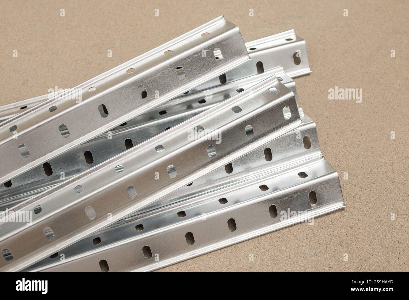 Perforated metal profile corners for adjustable shelving unit on beige ...