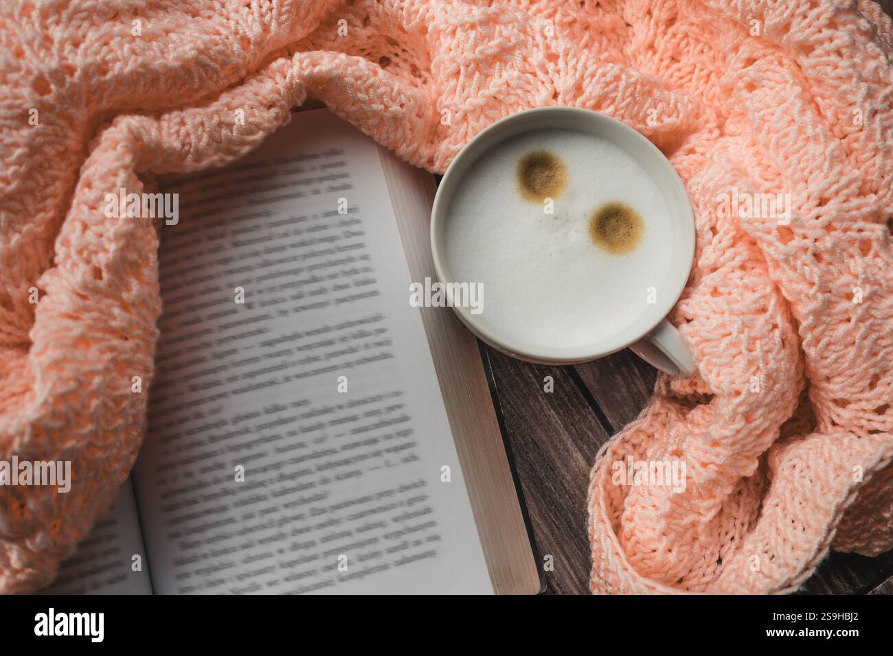 Warm cup of coffee, open book, beige soft warm blanket next to the ...