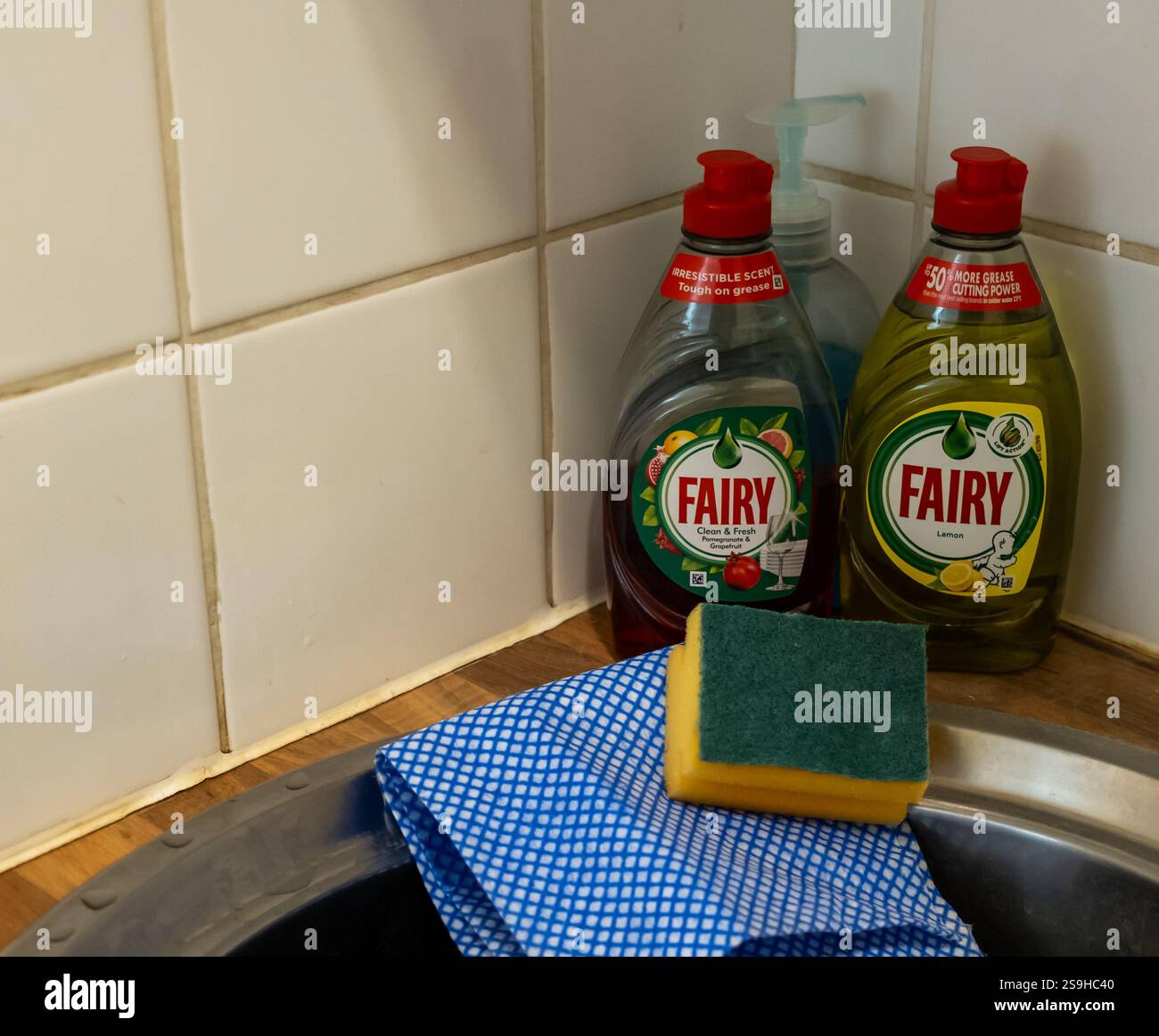 Fairy washing up liquid, scouring sponge and dish cloth by the kitchen ...