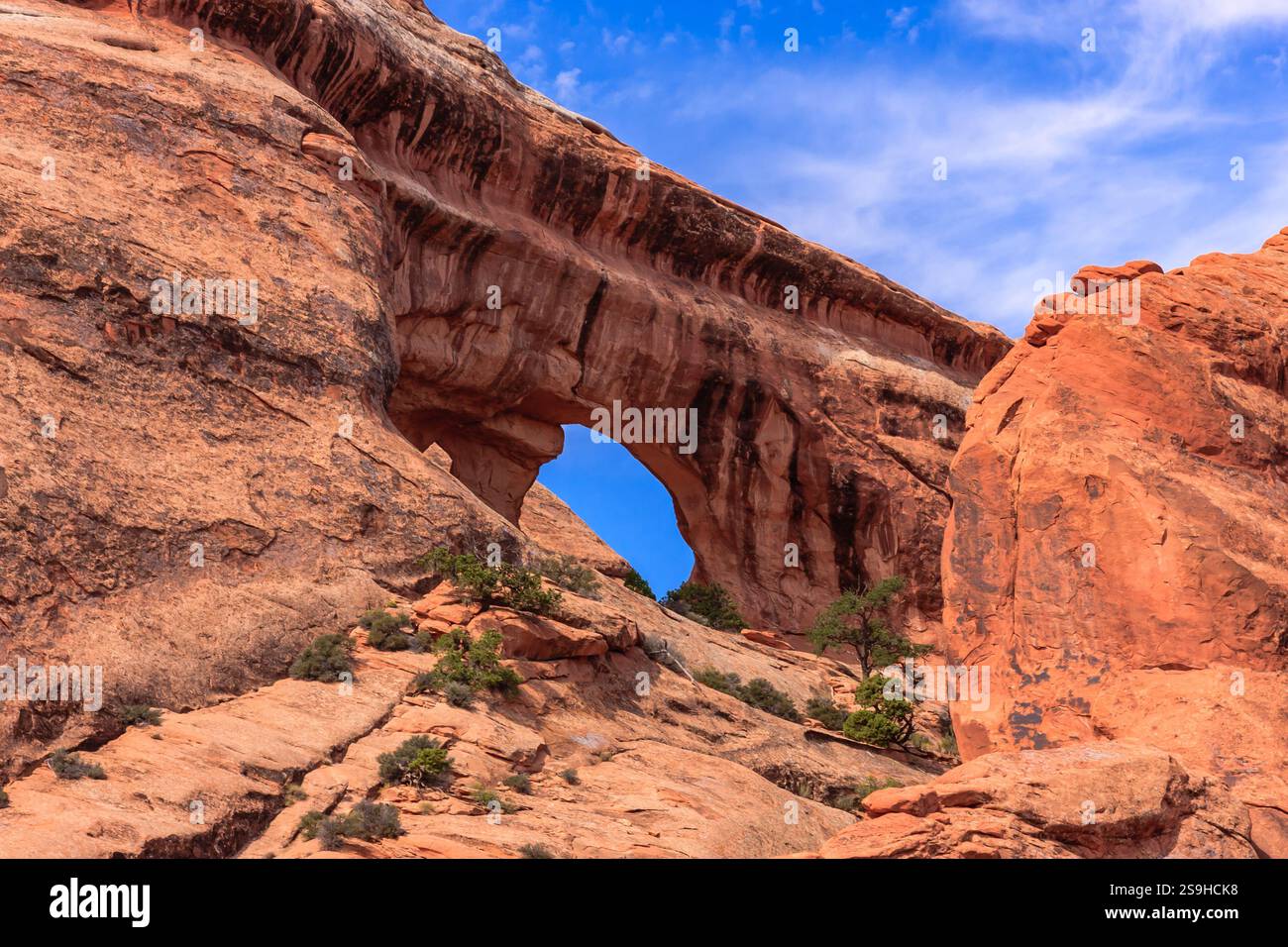 A large rock formation with a small hole in the middle. The hole is ...