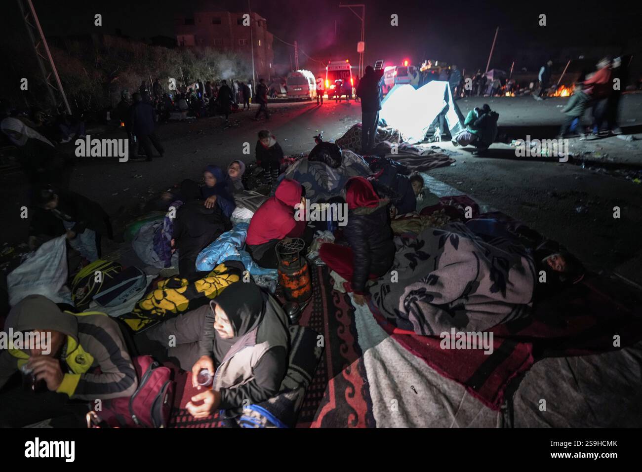 Displaced Palestinians gather with their belongings near a roadblock on ...