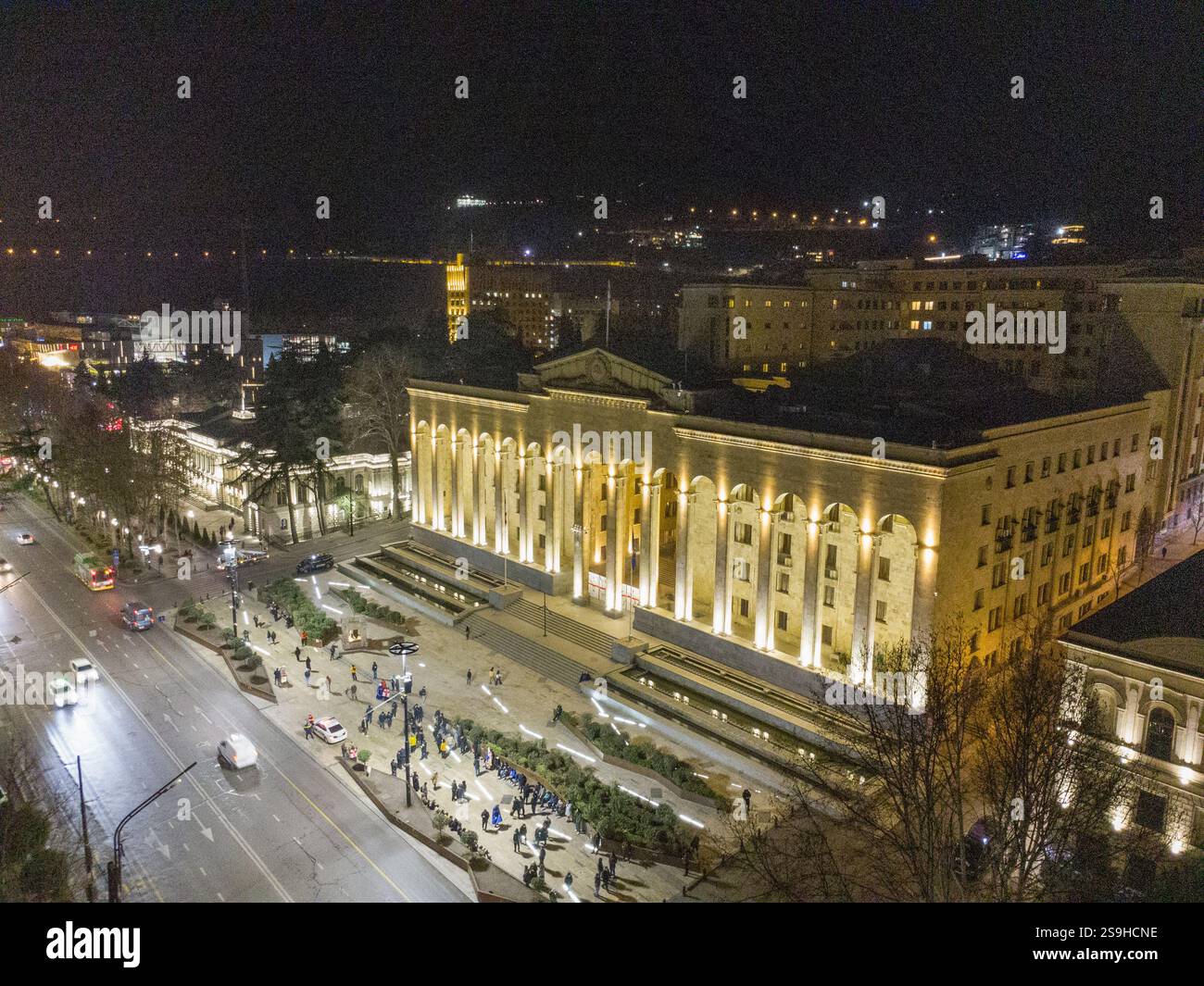 Drone view on Georgian Parliament building (lower right corner) and night city behind -Tbilisi ...