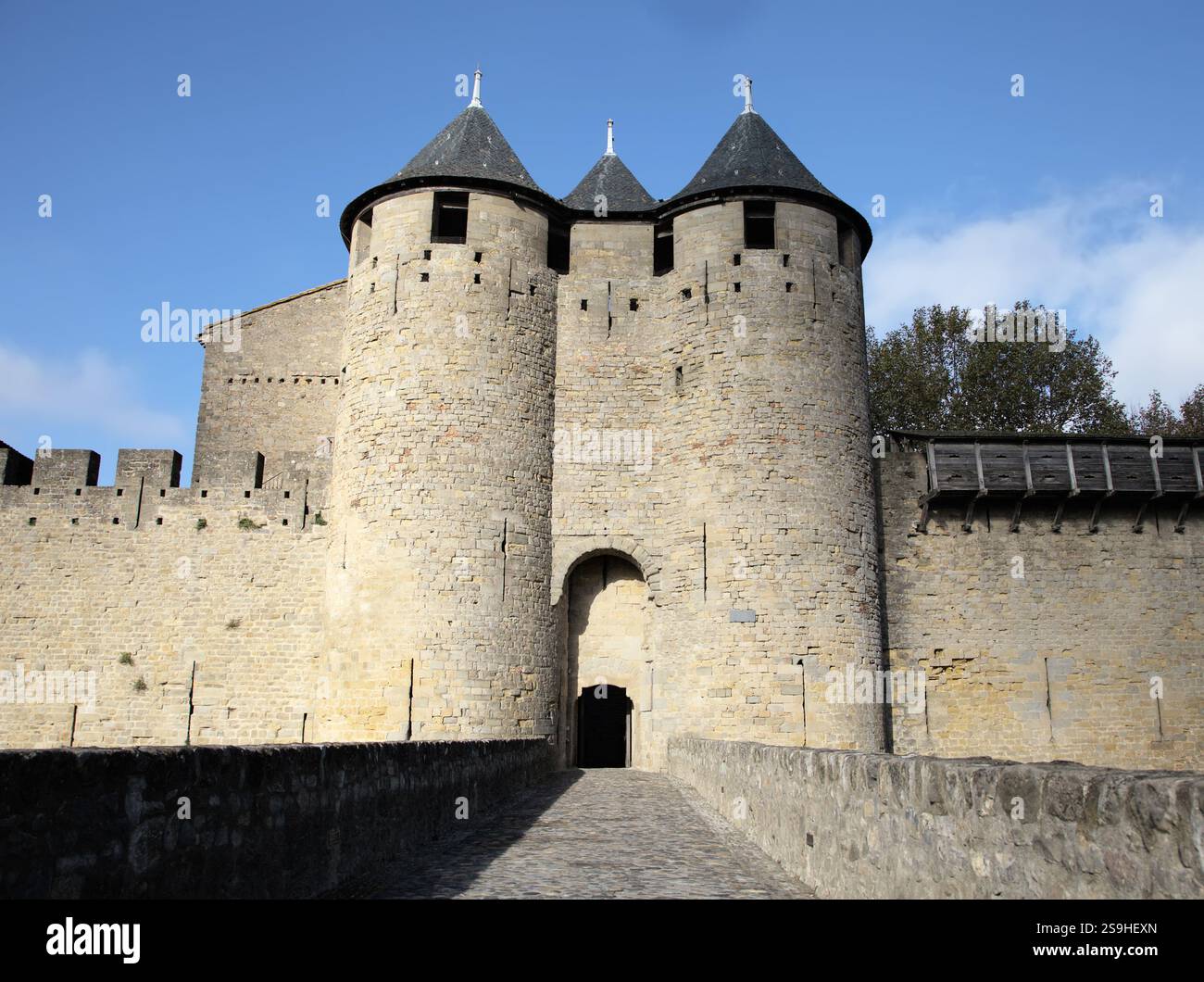 Visitors admire the impressive fortified walls and towers of ...