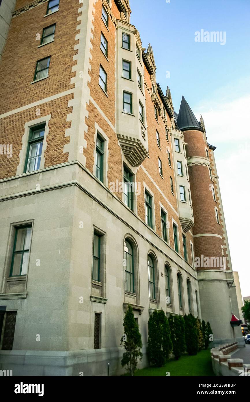 A large brick building with a green roof and a red roof. The building ...