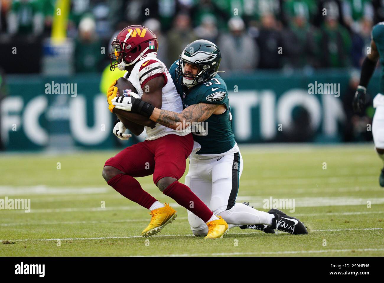 Washington Commanders wide receiver Olamide Zaccheaus, left, is tackled ...