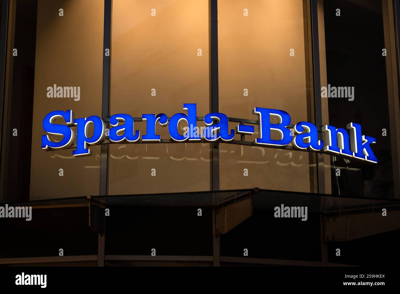 Aschaffenburg, Bavaria, Germany - 25 January 2025: The illuminated Sparda-Bank logo in blue ...