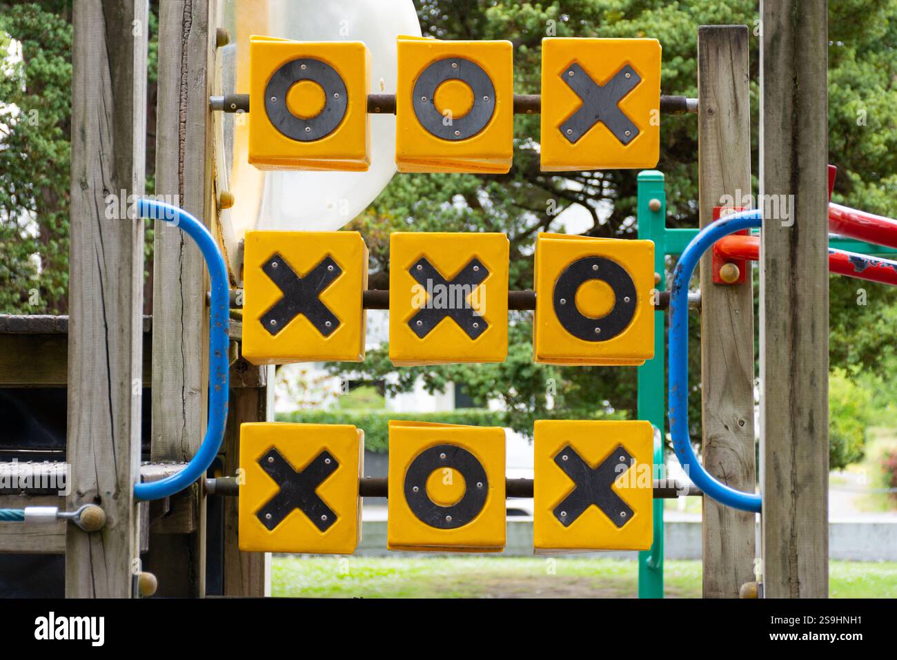 Yellow and black tic-tac-toe in a childrens playground with X winning ...