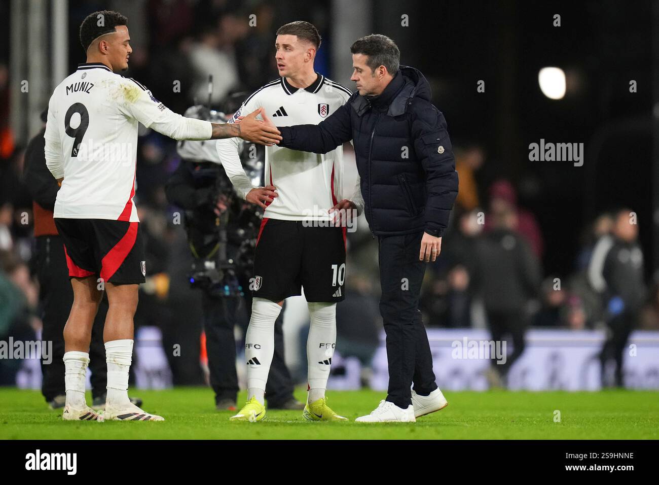 Fulham's head coach Marco Silva, right, shakes hands with Rodrigo Muniz ...