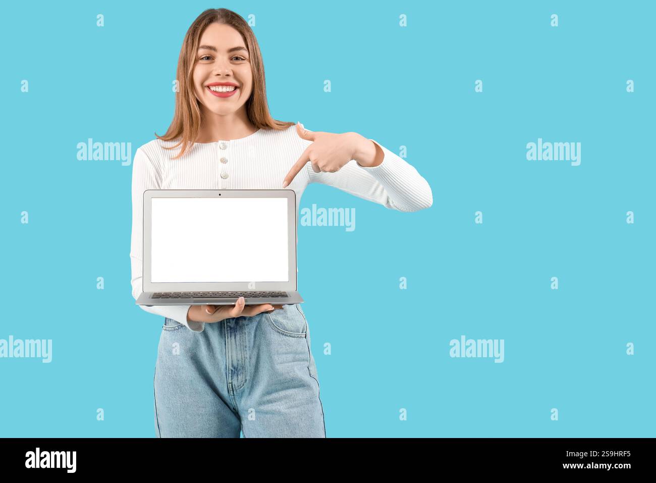 Female programmer pointing at blank laptop on blue background Stock ...