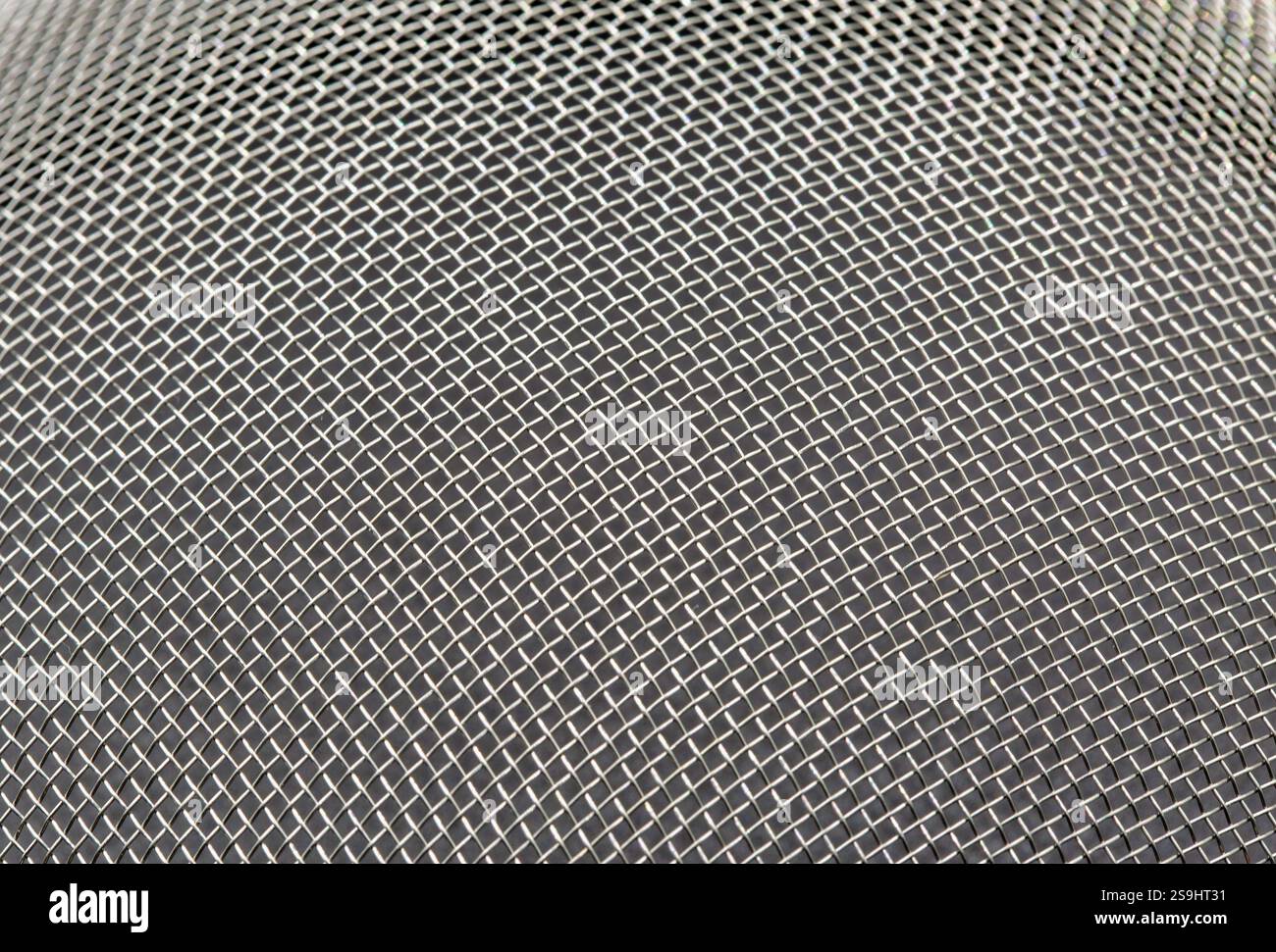 Abstract background made of stainless metal mesh with small holes ...