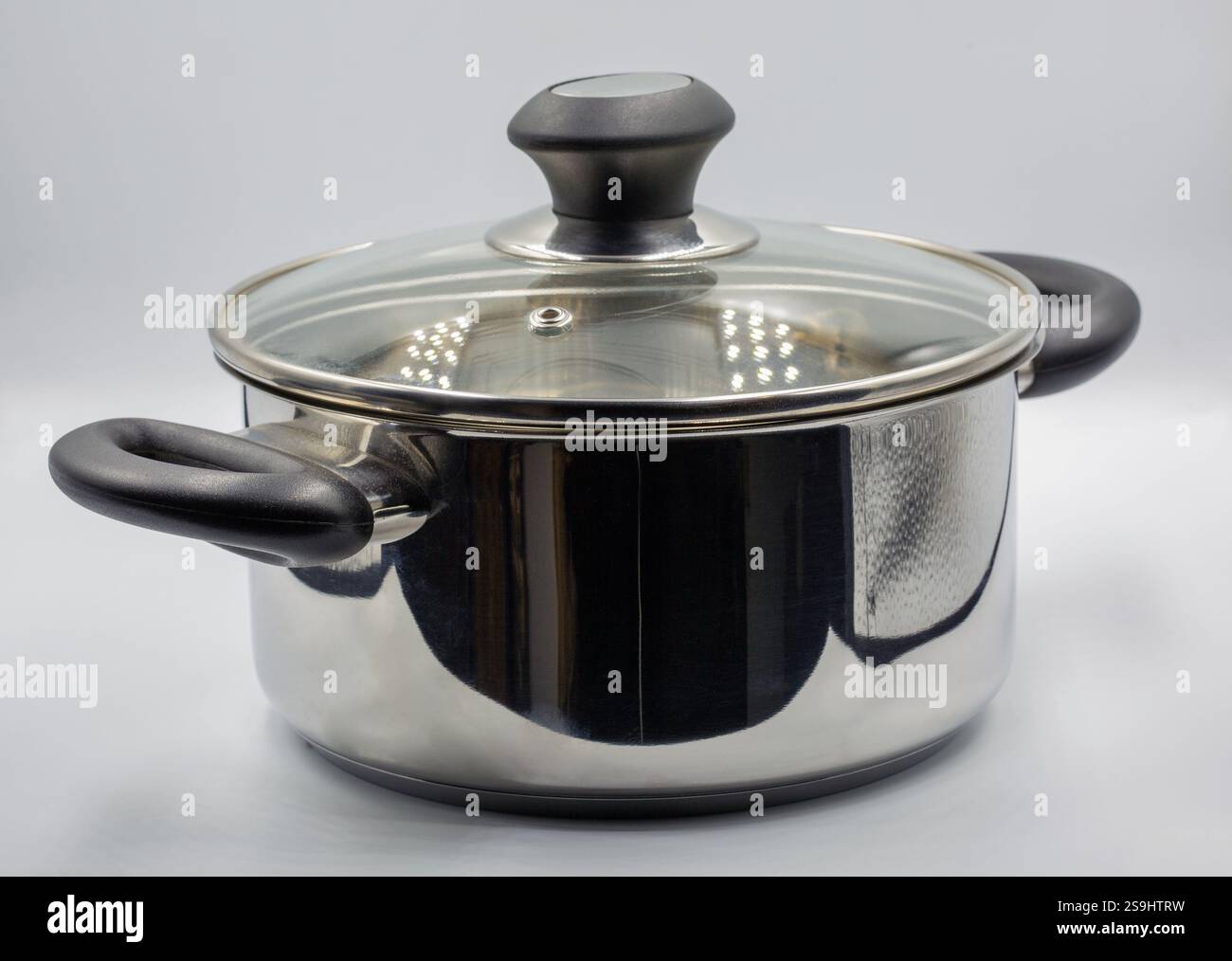 Studio shoot of large shiny stainless steel empty new saucepan closeup ...