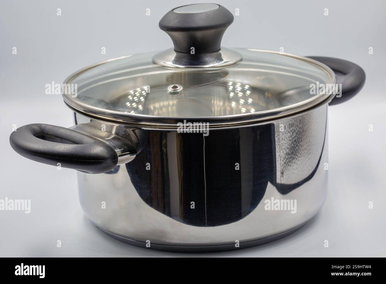 Studio shoot of large shiny stainless steel empty new saucepan closeup ...