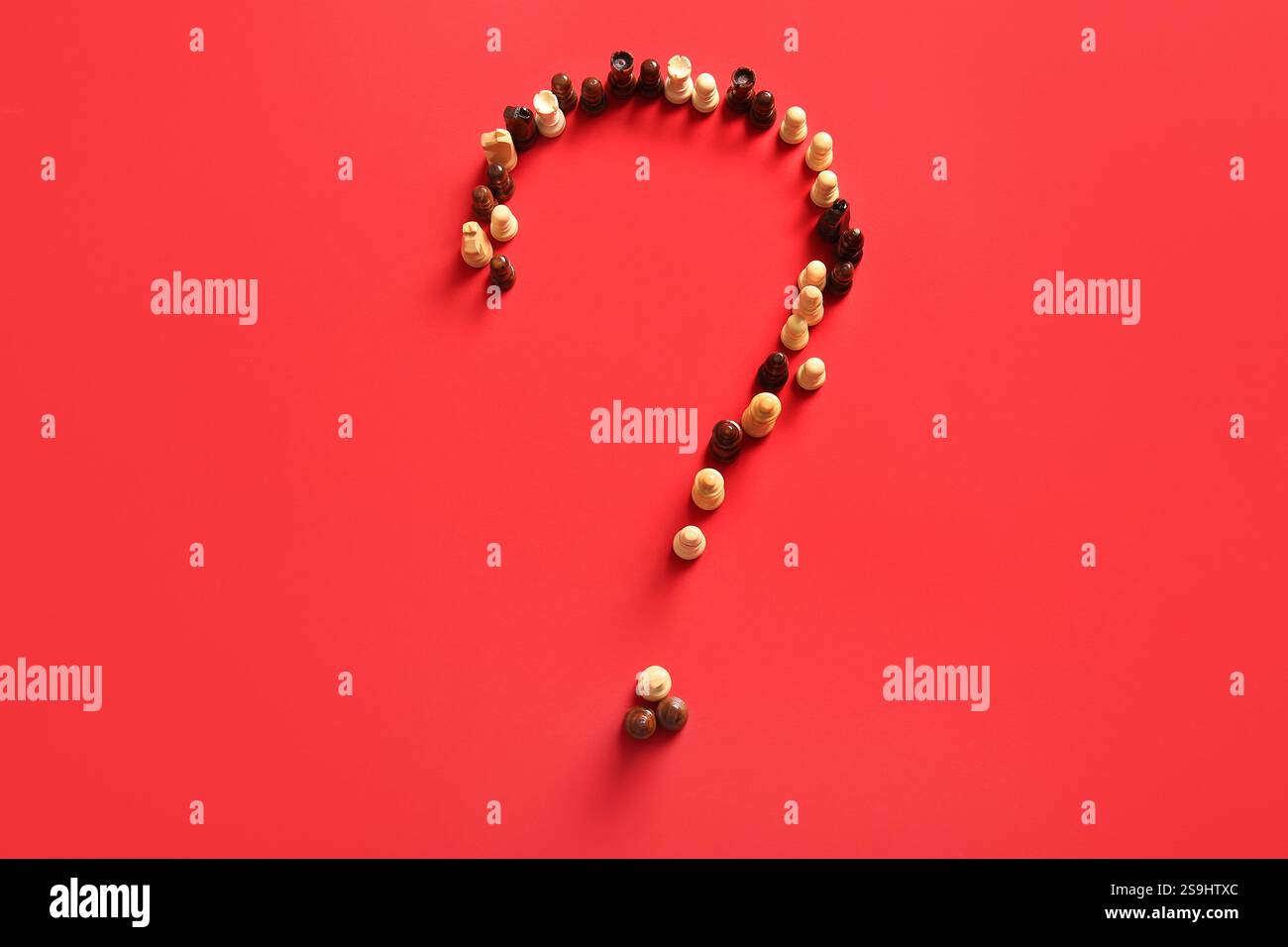 Question mark made of chess pieces on red background Stock Photo - Alamy