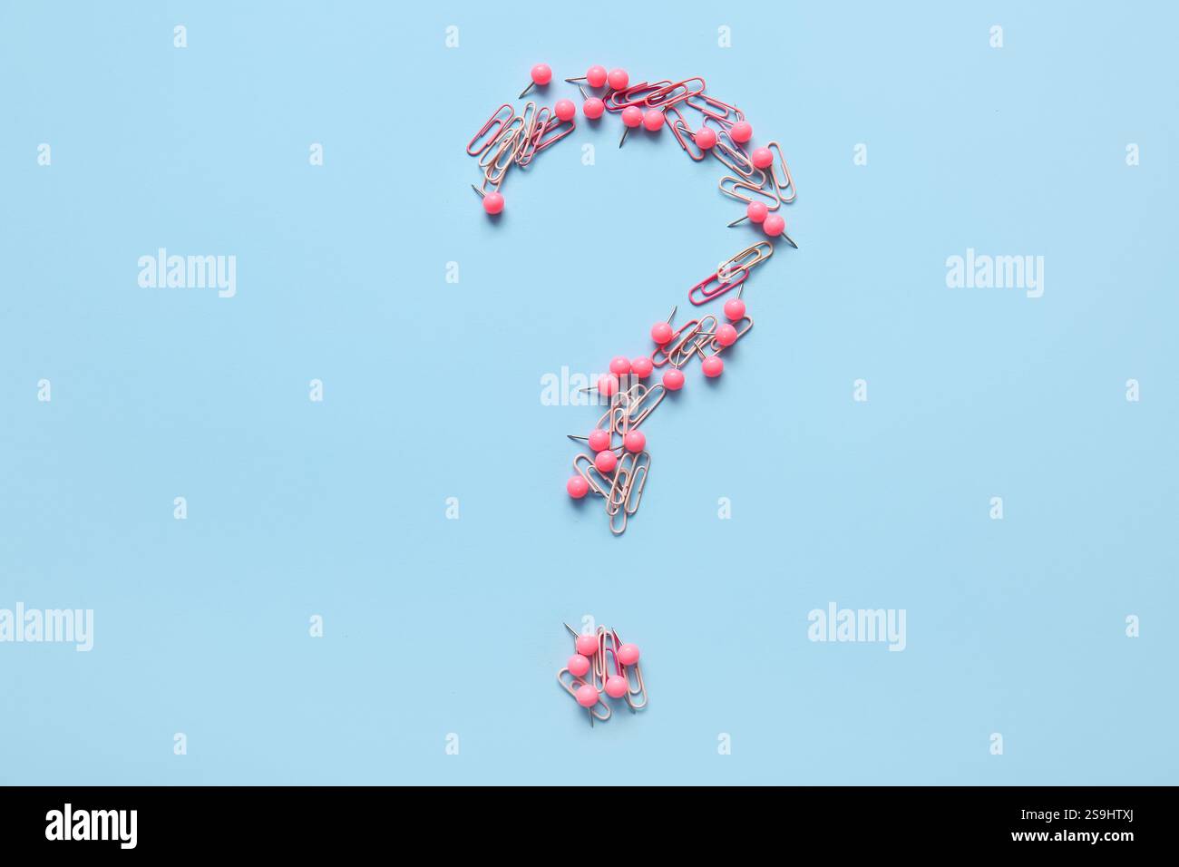 Question mark made of paper pins and clips on color background Stock ...