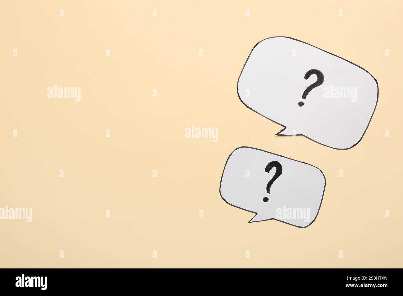 Speech bubbles with question marks on color background Stock Photo - Alamy