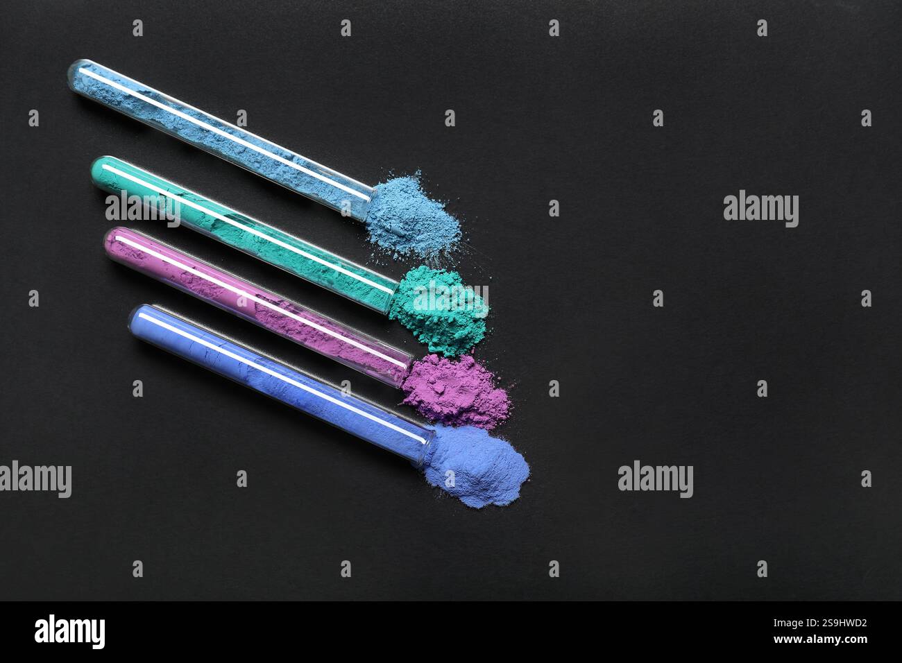 Tubes of powder pigments on black background Stock Photo - Alamy