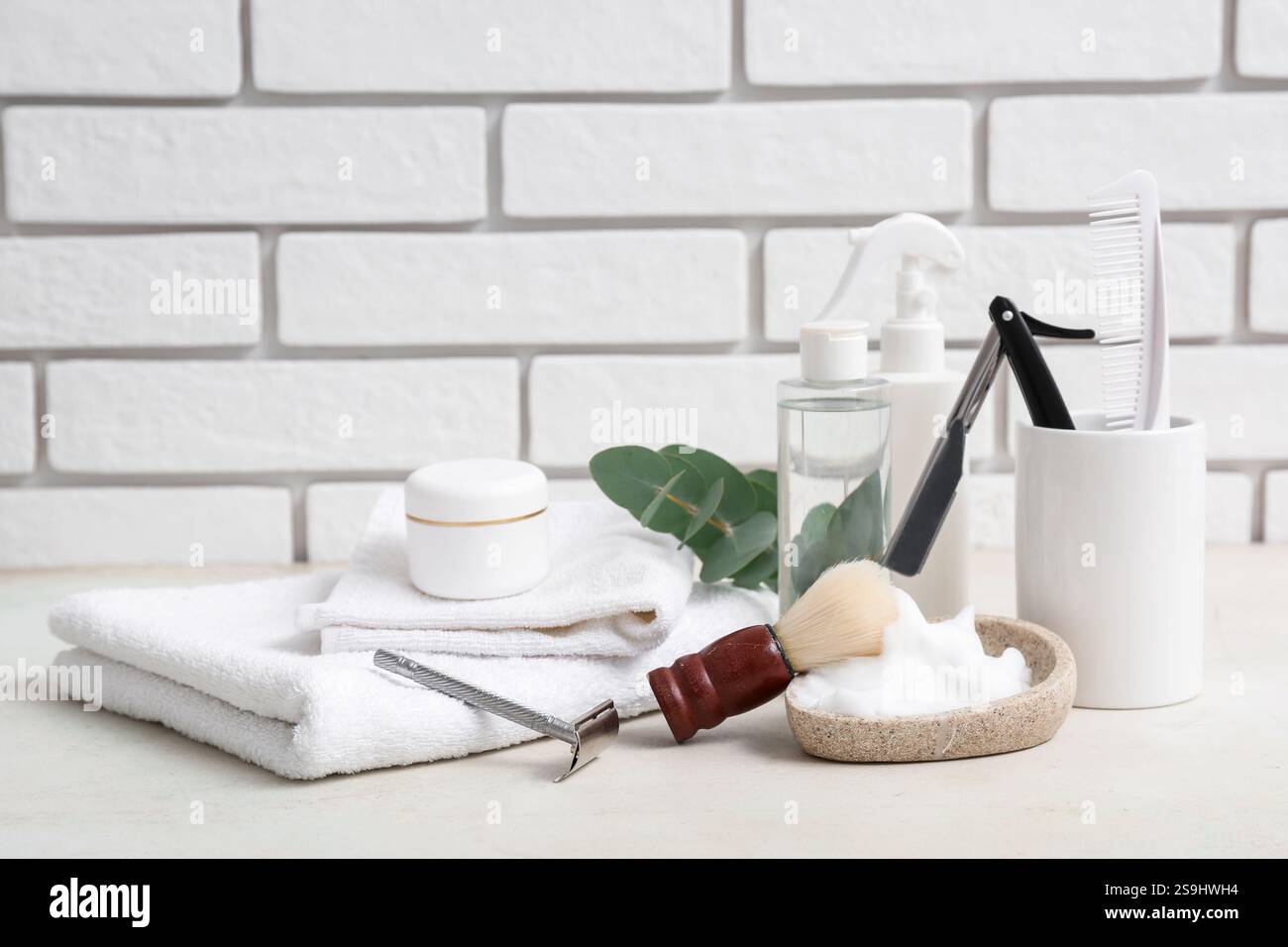 Set of men's shaving accessories with eucalyptus branch on table near ...